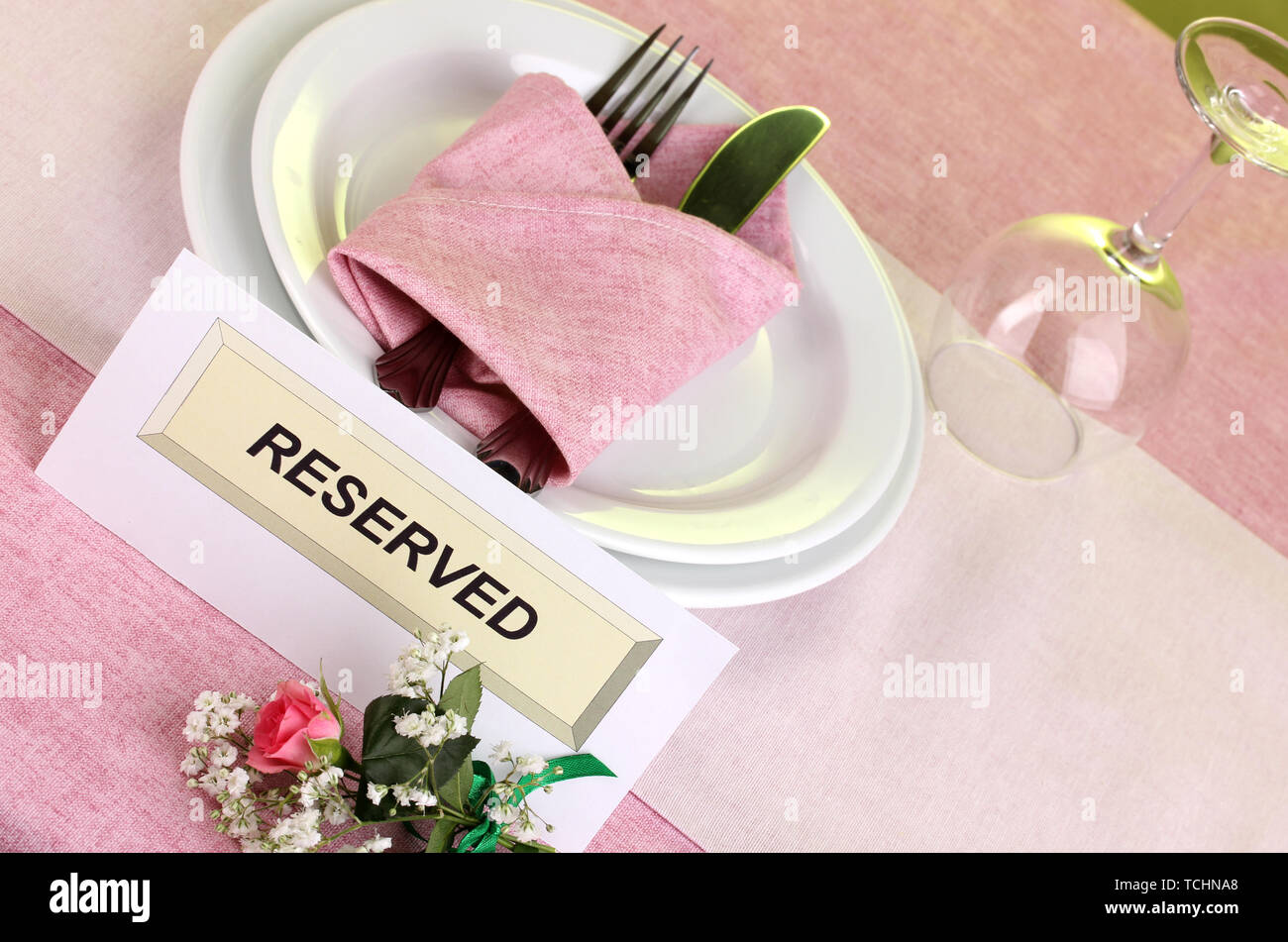 Table setting with reserved card in restaurant Stock Photo - Alamy