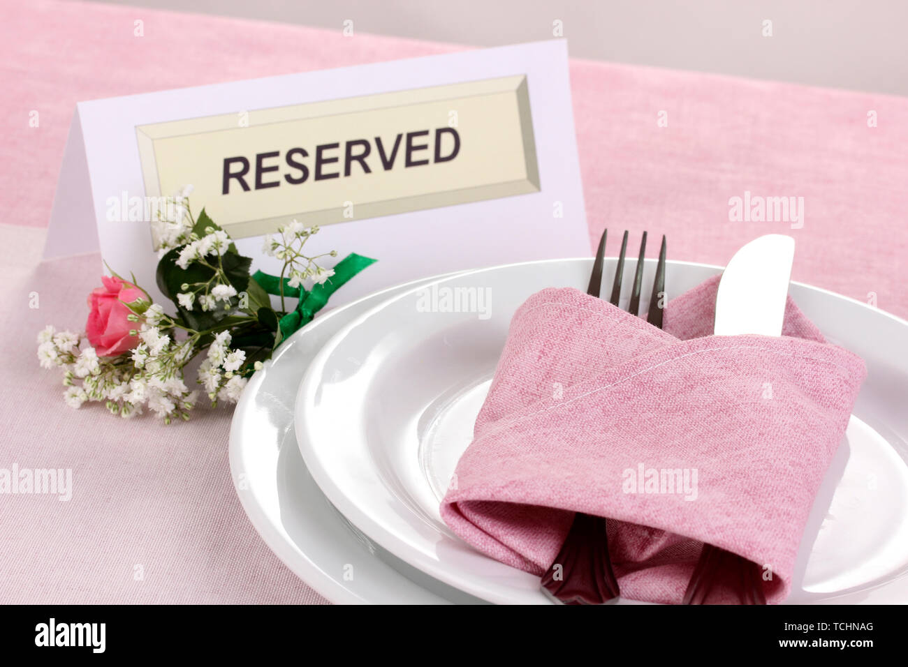 Table setting with reserved card in restaurant Stock Photo - Alamy