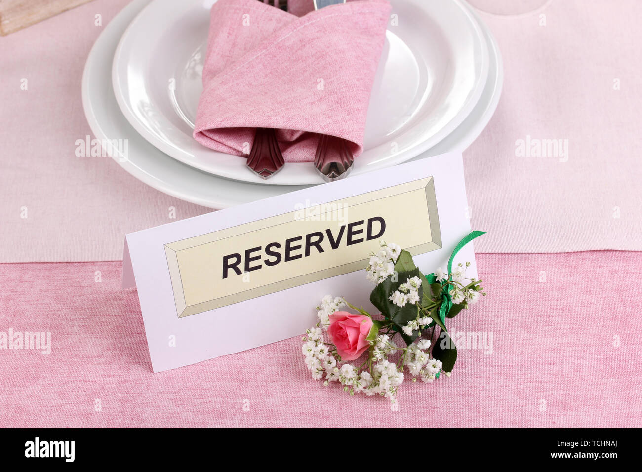 Table setting with reserved card in restaurant Stock Photo - Alamy