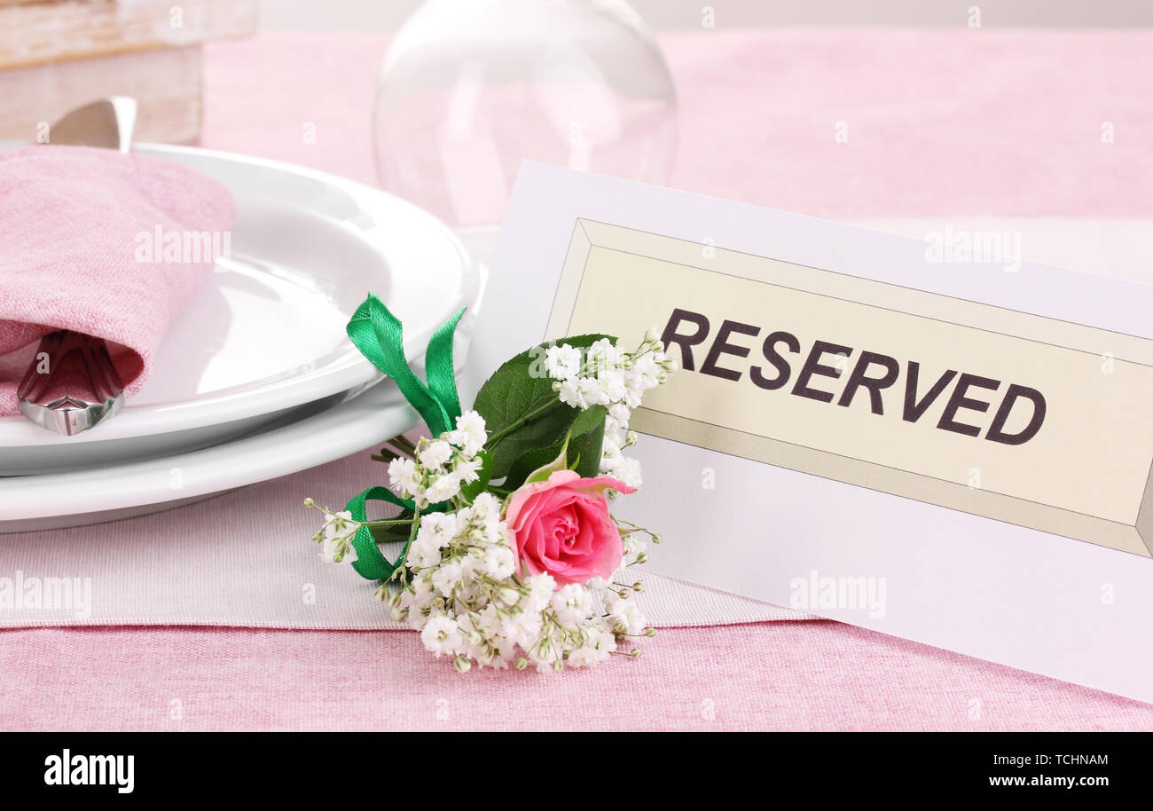 Table setting with reserved card in restaurant Stock Photo - Alamy