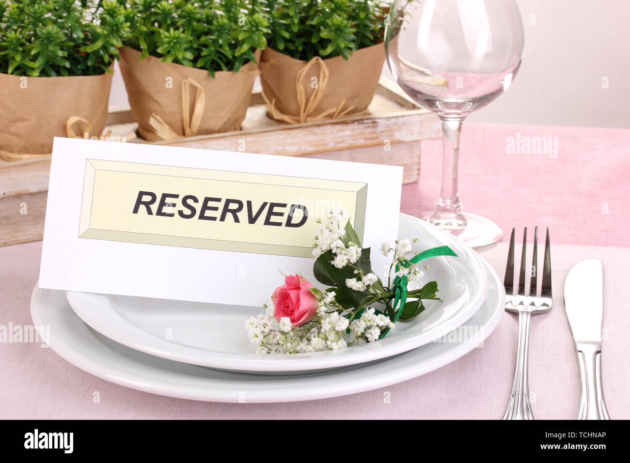 Table setting with reserved card in restaurant Stock Photo - Alamy