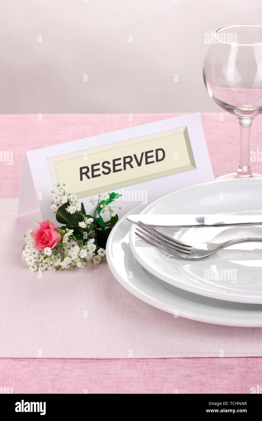 Table setting with reserved card in restaurant Stock Photo - Alamy