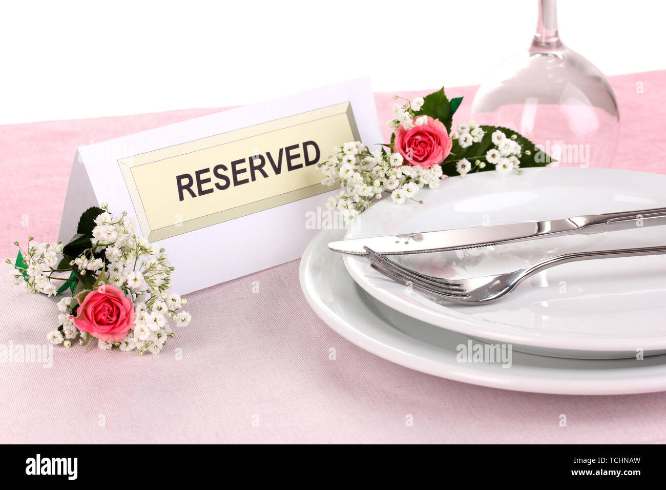 Table setting with reserved card in restaurant Stock Photo - Alamy