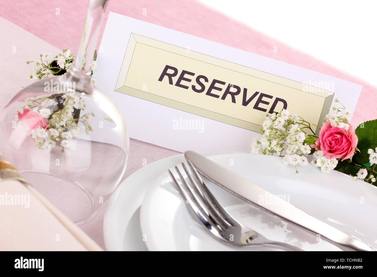 Table setting with reserved card in restaurant Stock Photo - Alamy