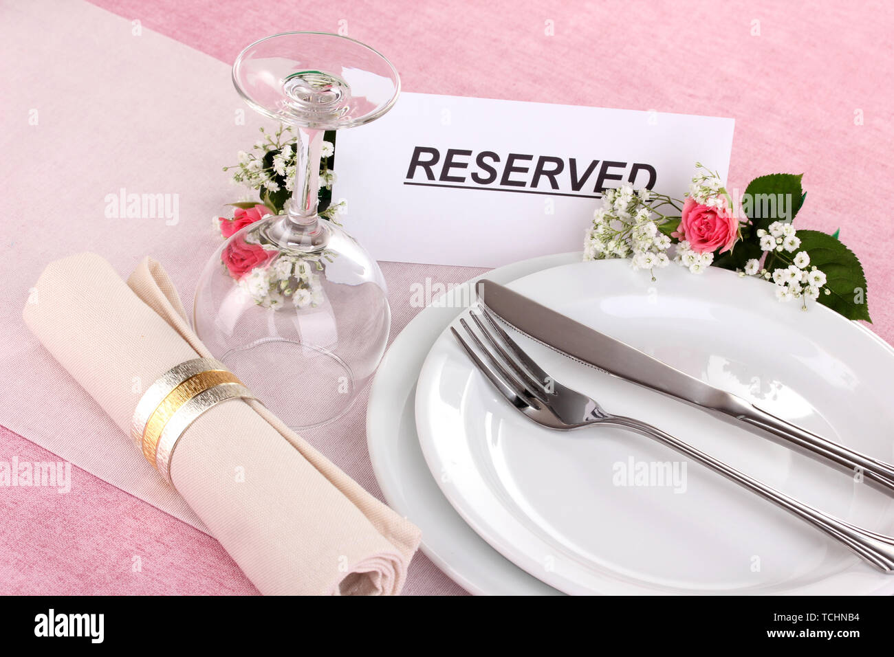Table setting with reserved card in restaurant Stock Photo - Alamy