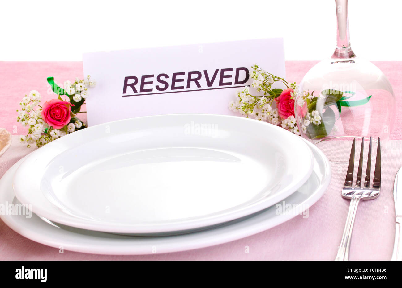 Table setting with reserved card in restaurant Stock Photo - Alamy