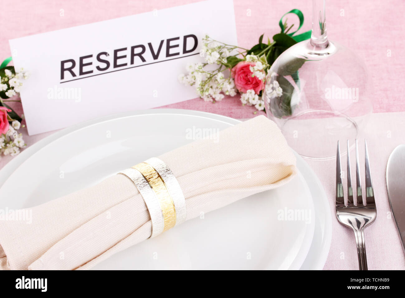 Table setting with reserved card in restaurant Stock Photo - Alamy