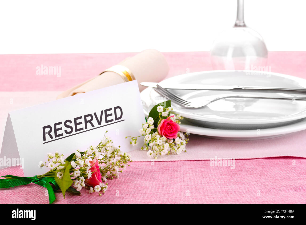 Table setting with reserved card in restaurant Stock Photo - Alamy