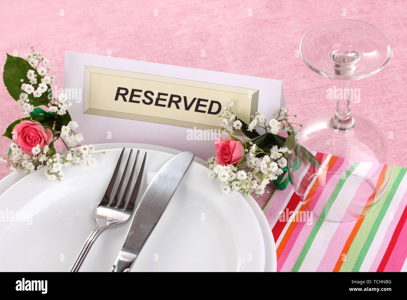 Table setting with reserved card in restaurant Stock Photo - Alamy