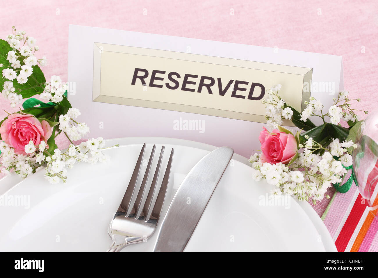 Table setting with reserved card in restaurant Stock Photo - Alamy
