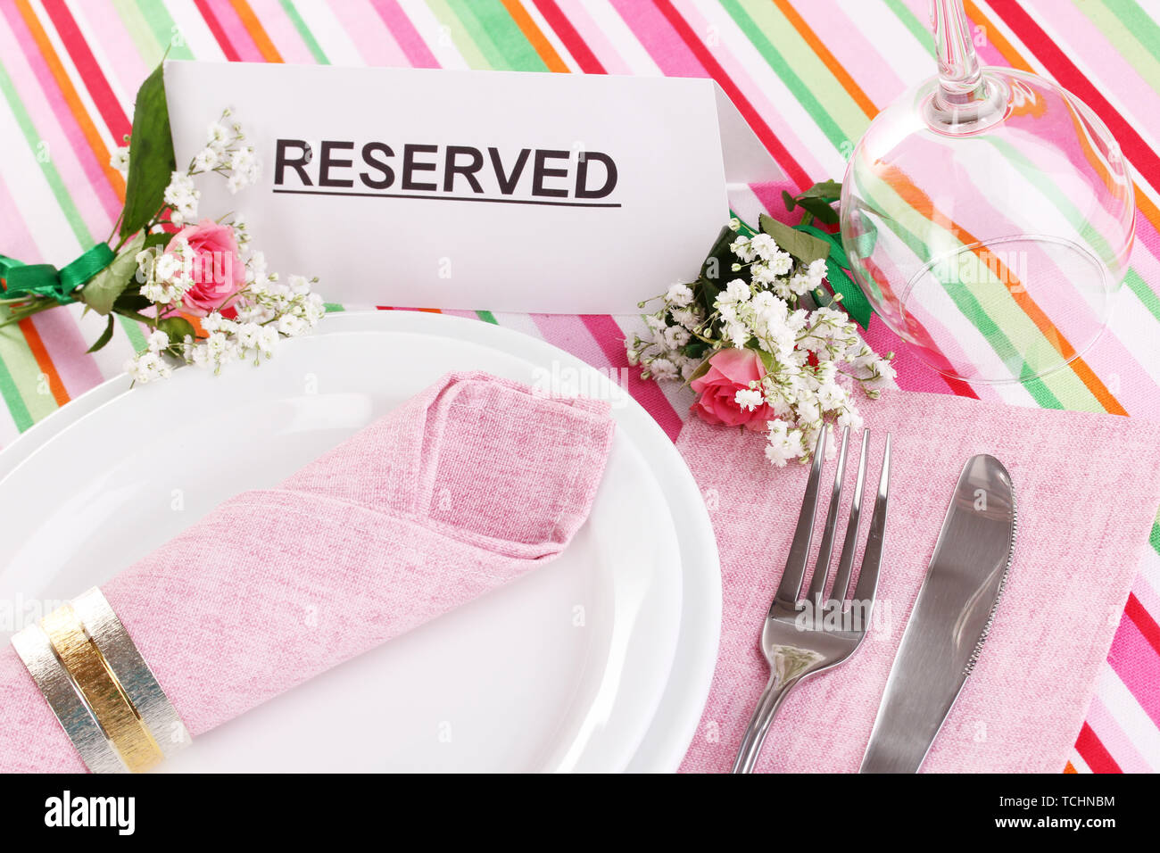 Table setting with reserved card in restaurant Stock Photo - Alamy
