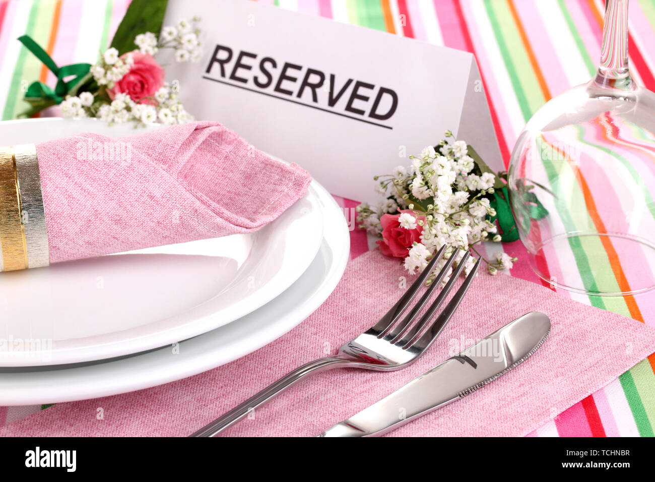 Table setting with reserved card in restaurant Stock Photo - Alamy