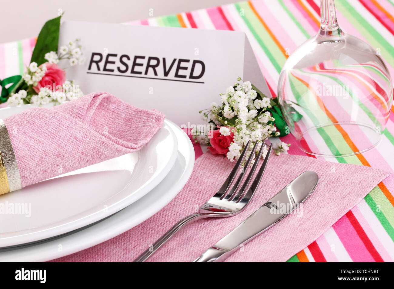 Table setting with reserved card in restaurant Stock Photo - Alamy