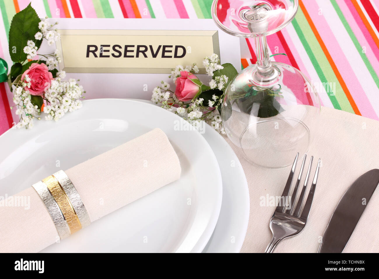 Table setting with reserved card in restaurant Stock Photo - Alamy