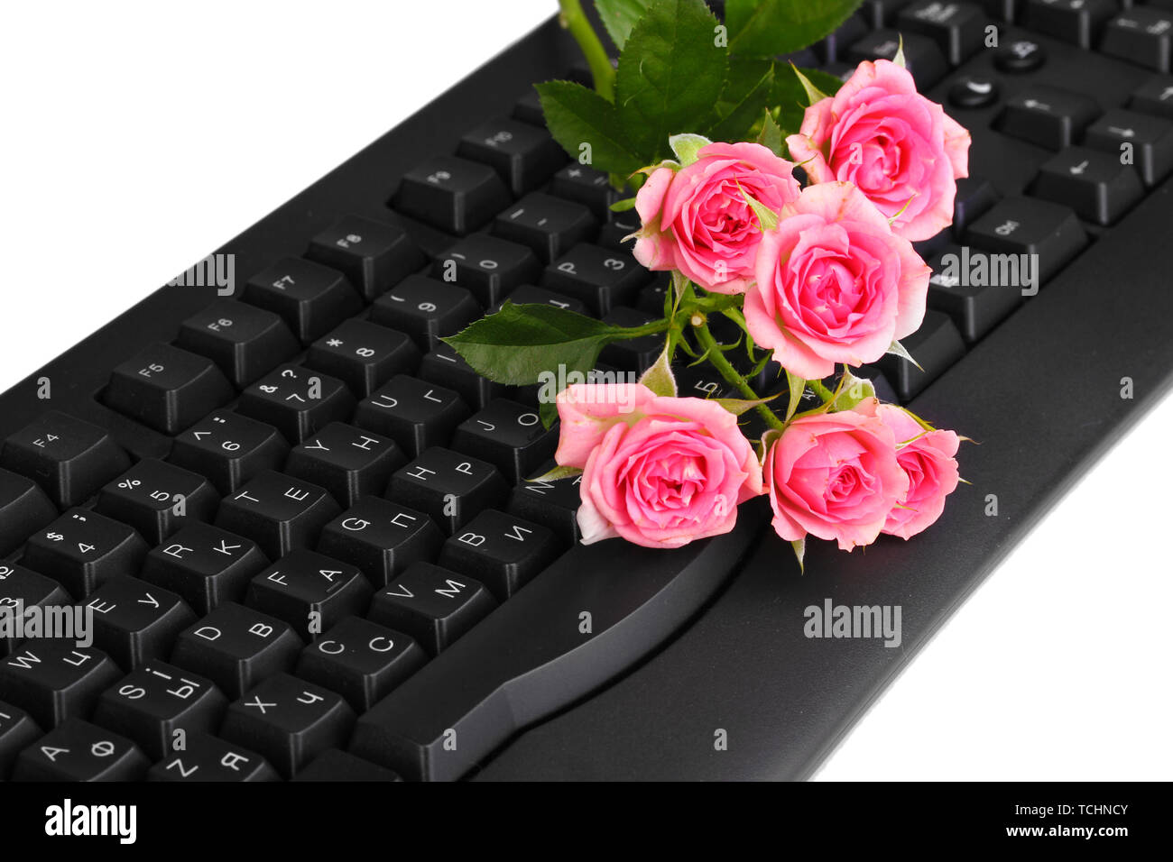 Pink roses on keyboard close-up internet communication Stock Photo - Alamy