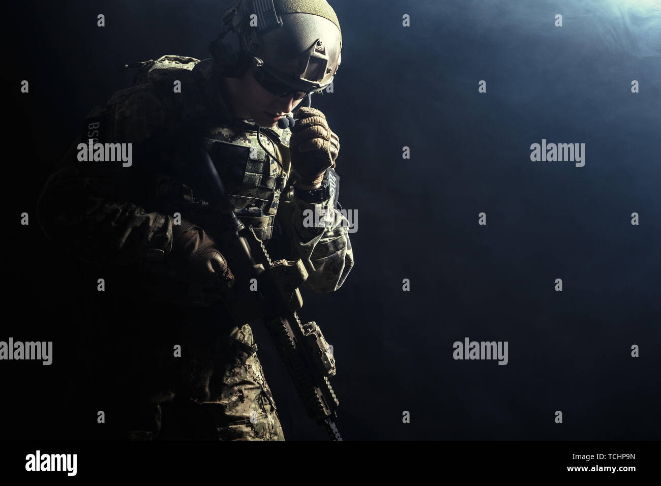 Special forces soldier with rifle on dark background Stock Photo - Alamy