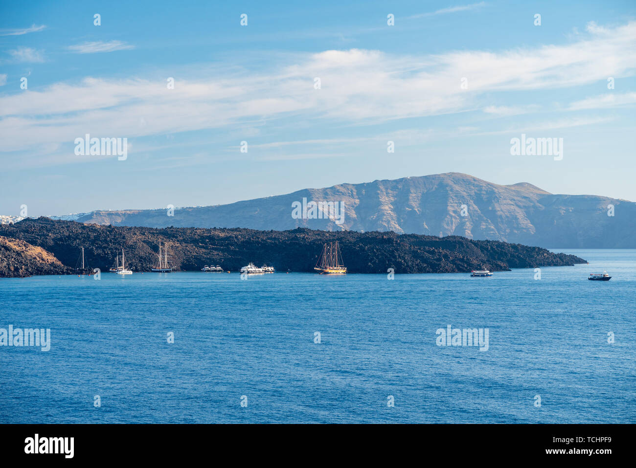 Small boats in harbor of the volcanic caldera island by Santorini Stock ...