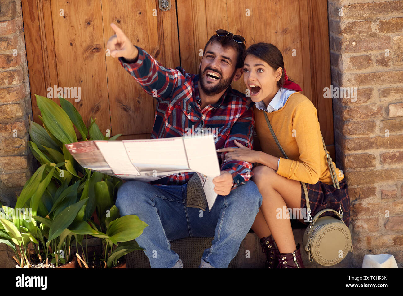 Smiling tourist couple using map as guide on vacation Stock Photo - Alamy
