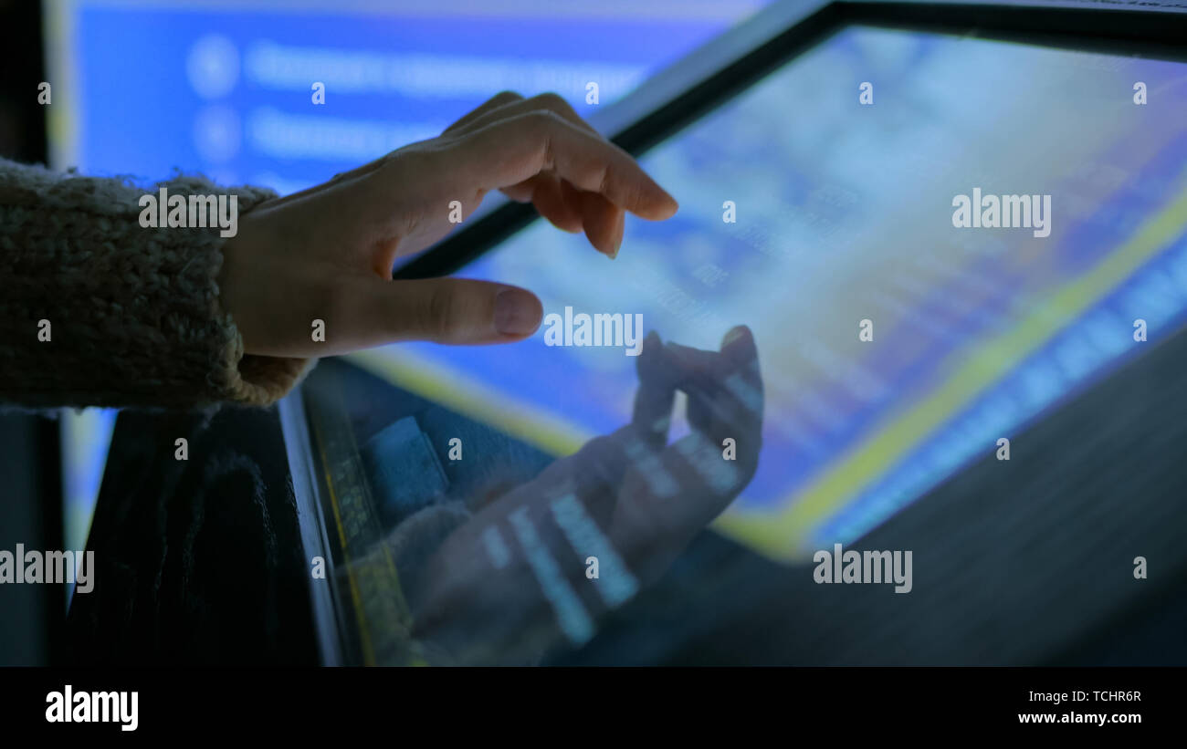Woman using interactive touchscreen display Stock Photo - Alamy