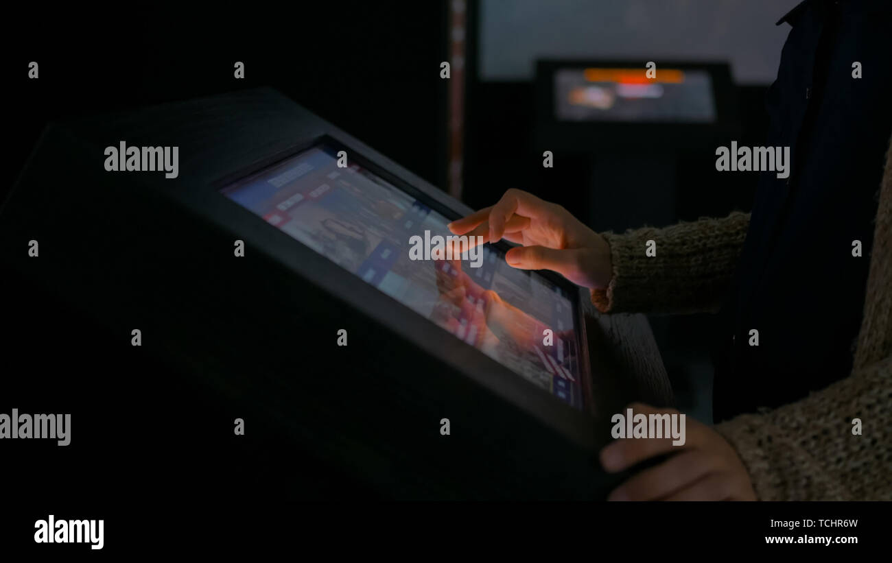 Woman using interactive touchscreen display Stock Photo - Alamy