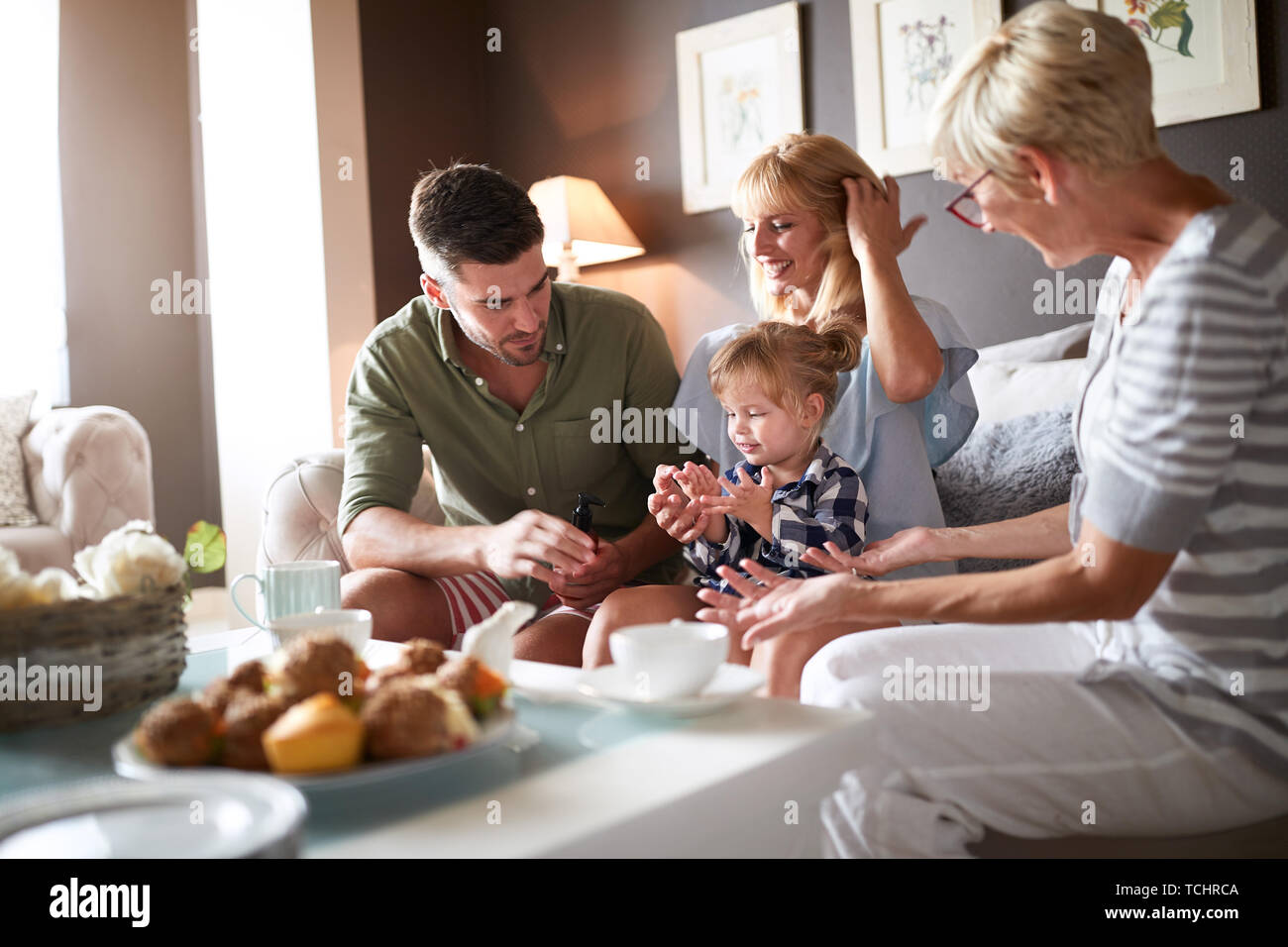 Young family with cute child visiting grandma Stock Photo - Alamy