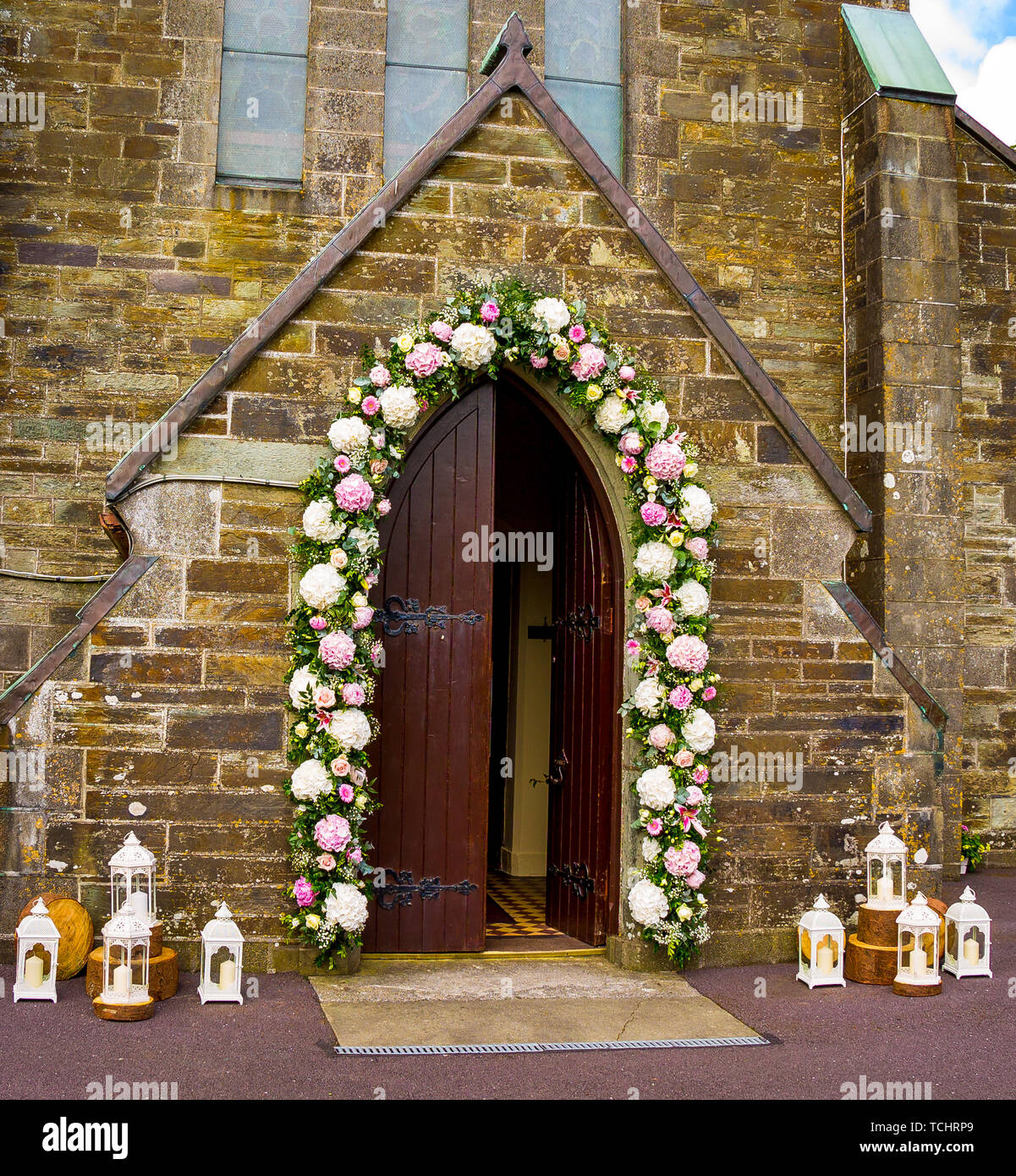 Wedding flower display around a church door Stock Photo - Alamy
