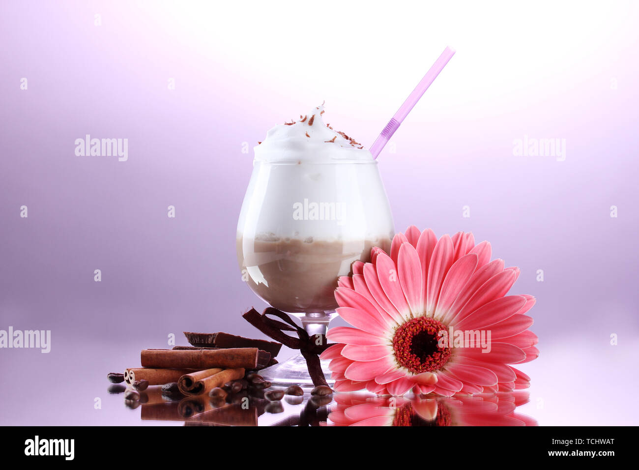 glass of coffee cocktail and gerbera flower on purple background Stock ...