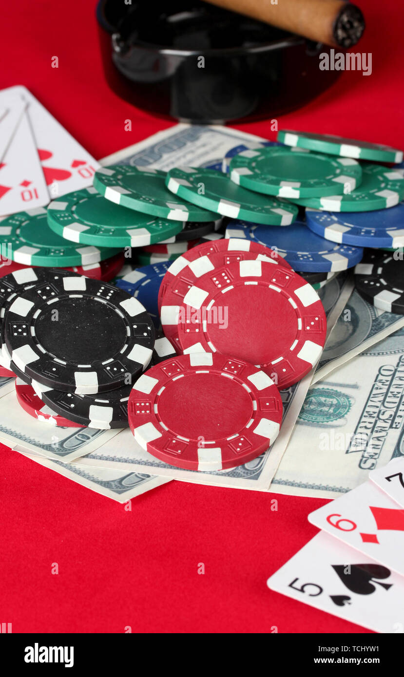 The red poker table with playing cards, poker chips and dollars Stock ...