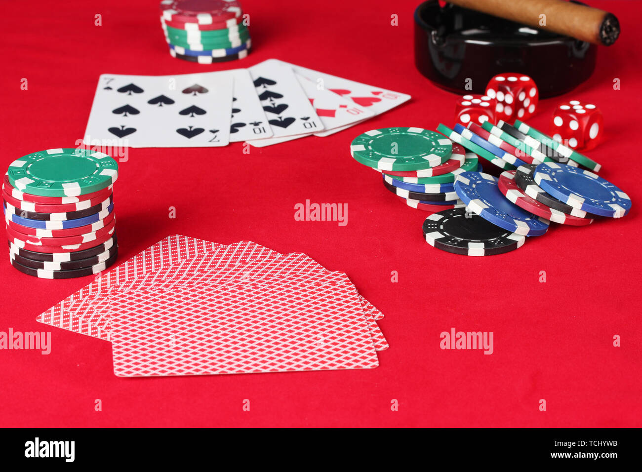The red poker table with playing cards. A combination of four of a kind ...