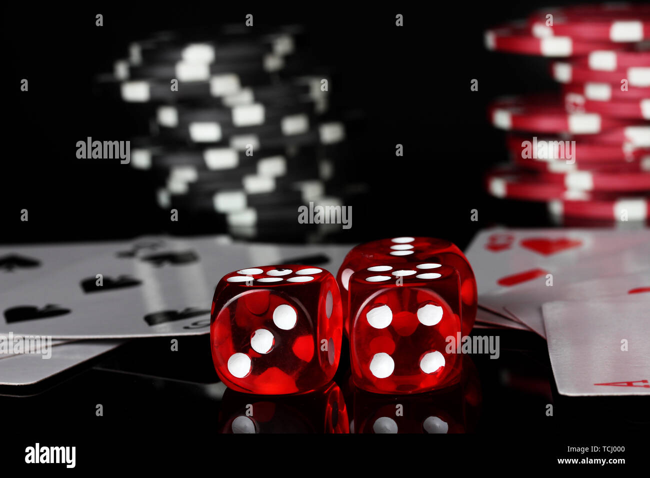winning combination of playing cards with poker chips and dice on black ...