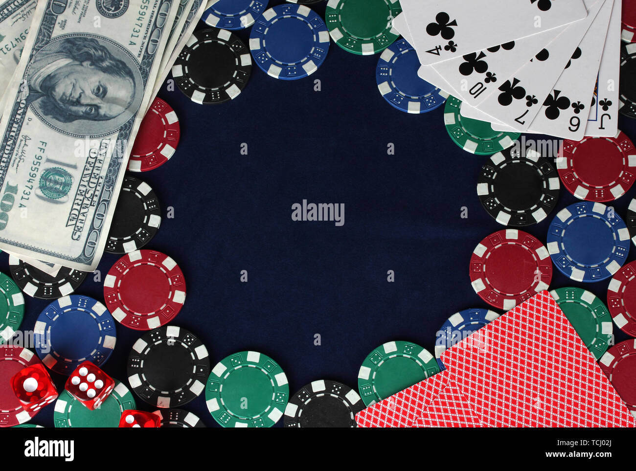 frame made of poker chips, playing cards and dollars on the blue ...