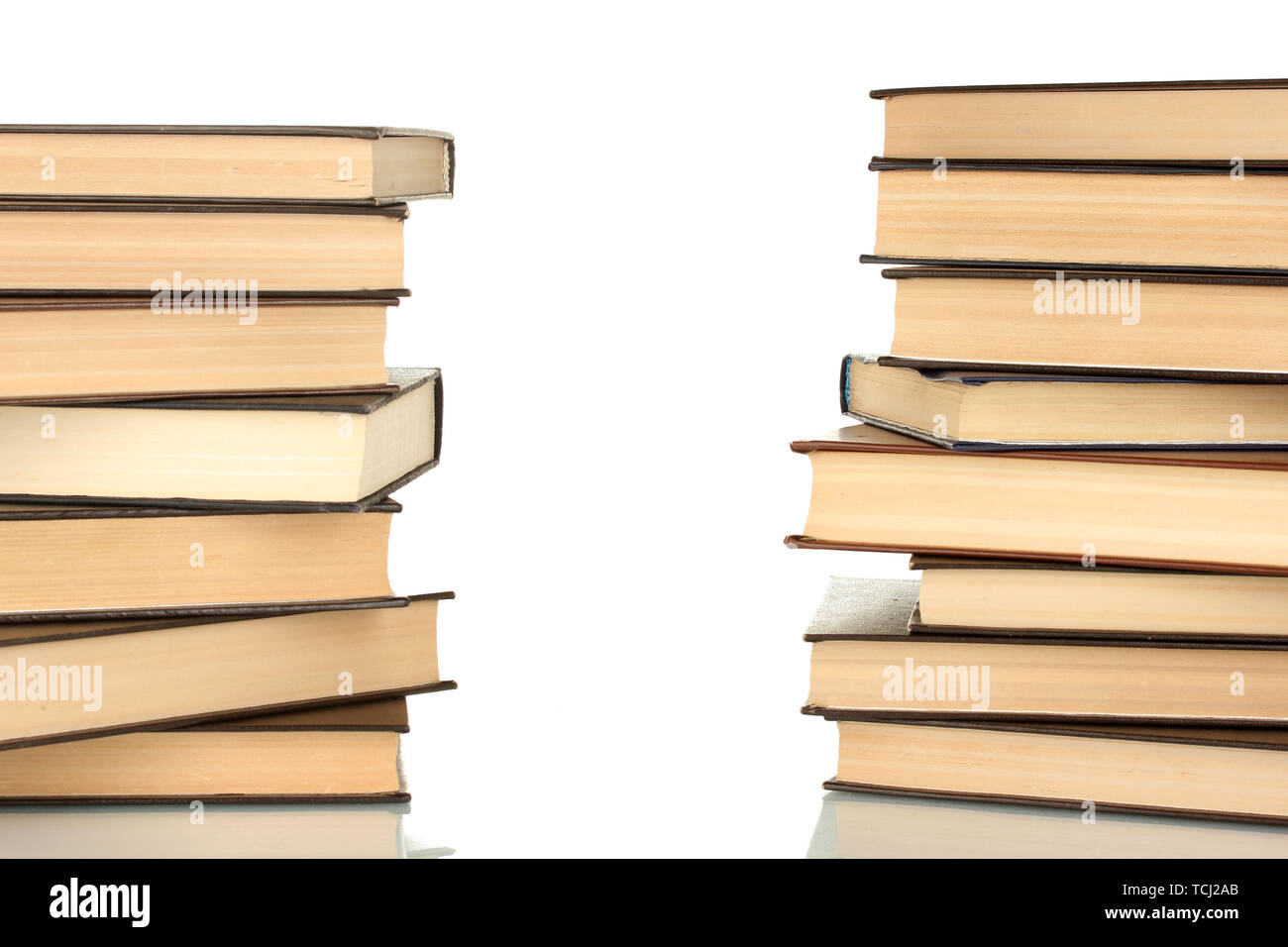 Two towers of books on white background close-up Stock Photo - Alamy