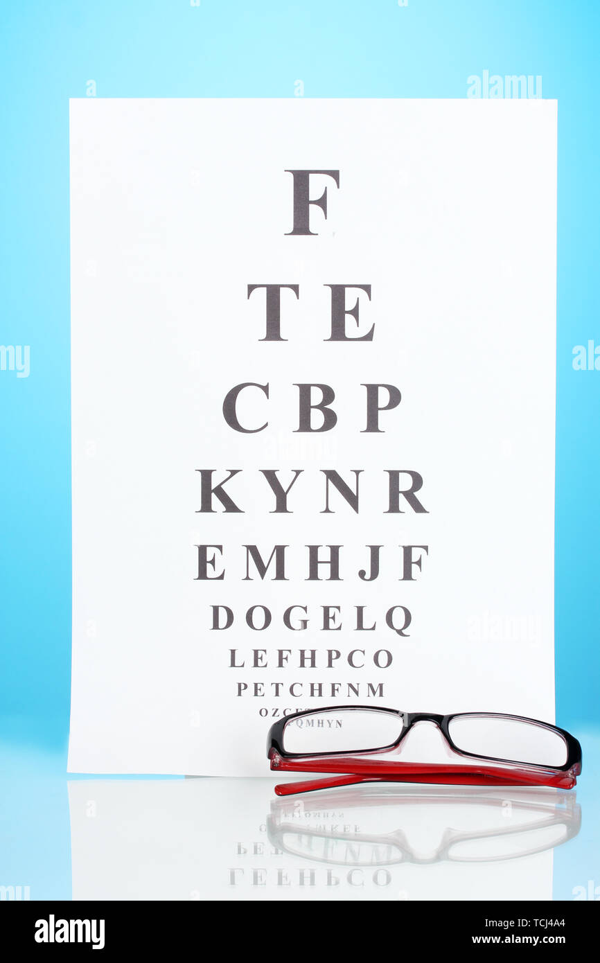 Eyesight test chart with glasses on blue background close-up Stock ...