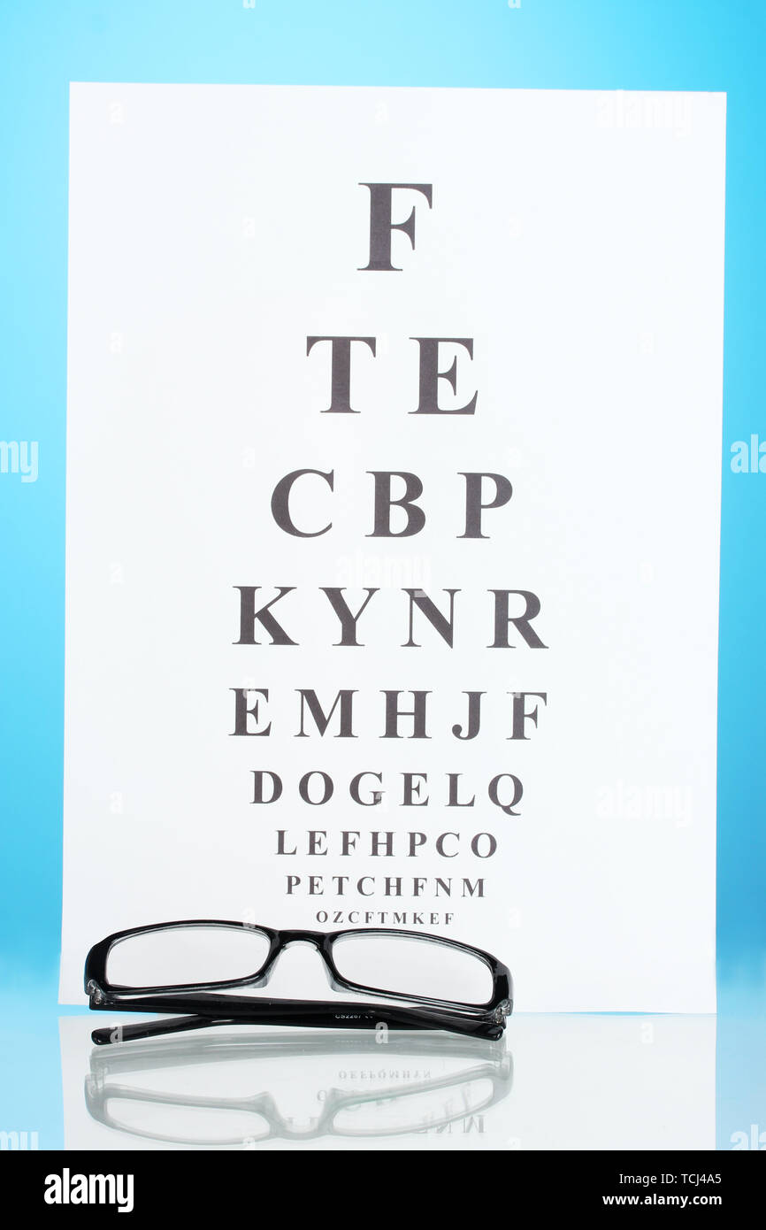 Eyesight test chart with glasses on blue background close-up Stock ...
