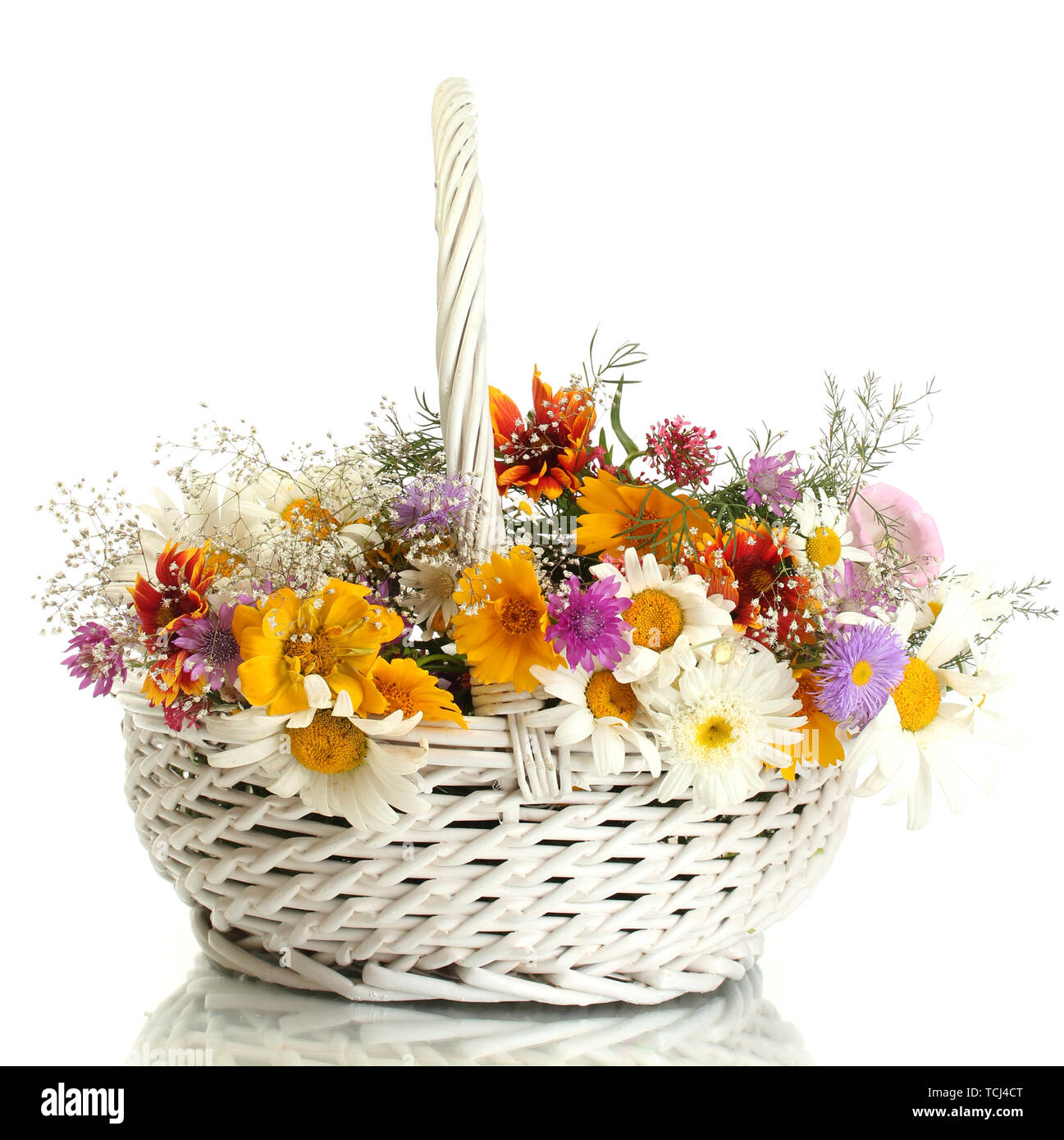 beautiful bouquet of bright wildflowers in basket, isolated on white ...