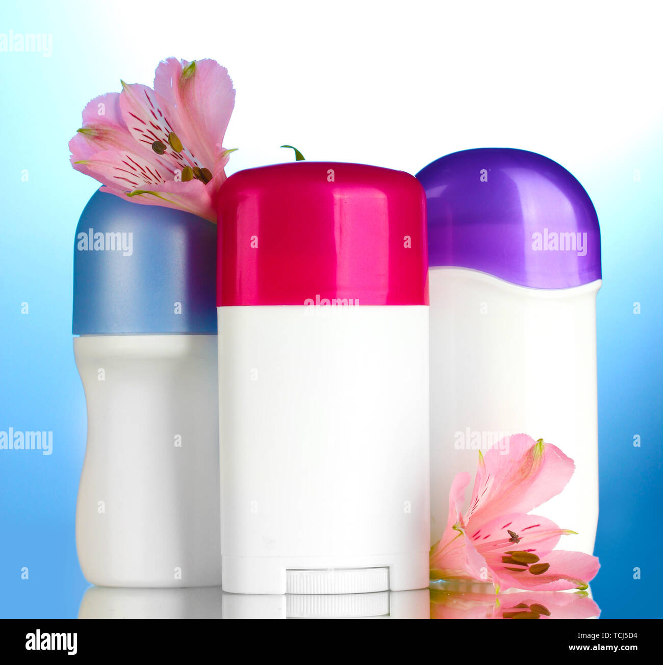 deodorants with flowers on blue background Stock Photo - Alamy