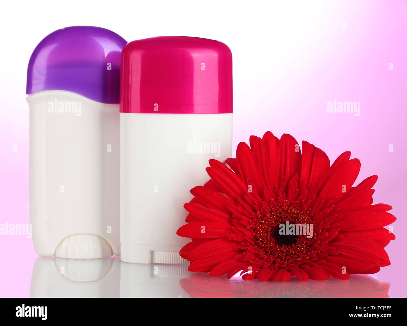 deodorants with flower on pink background Stock Photo - Alamy