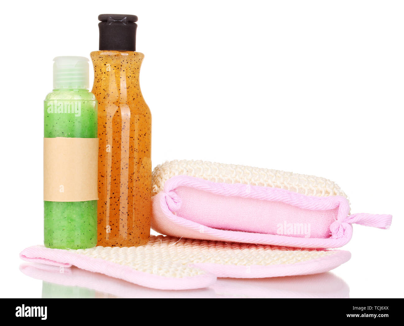 Bottles with scrub and sponges isolated on white Stock Photo - Alamy
