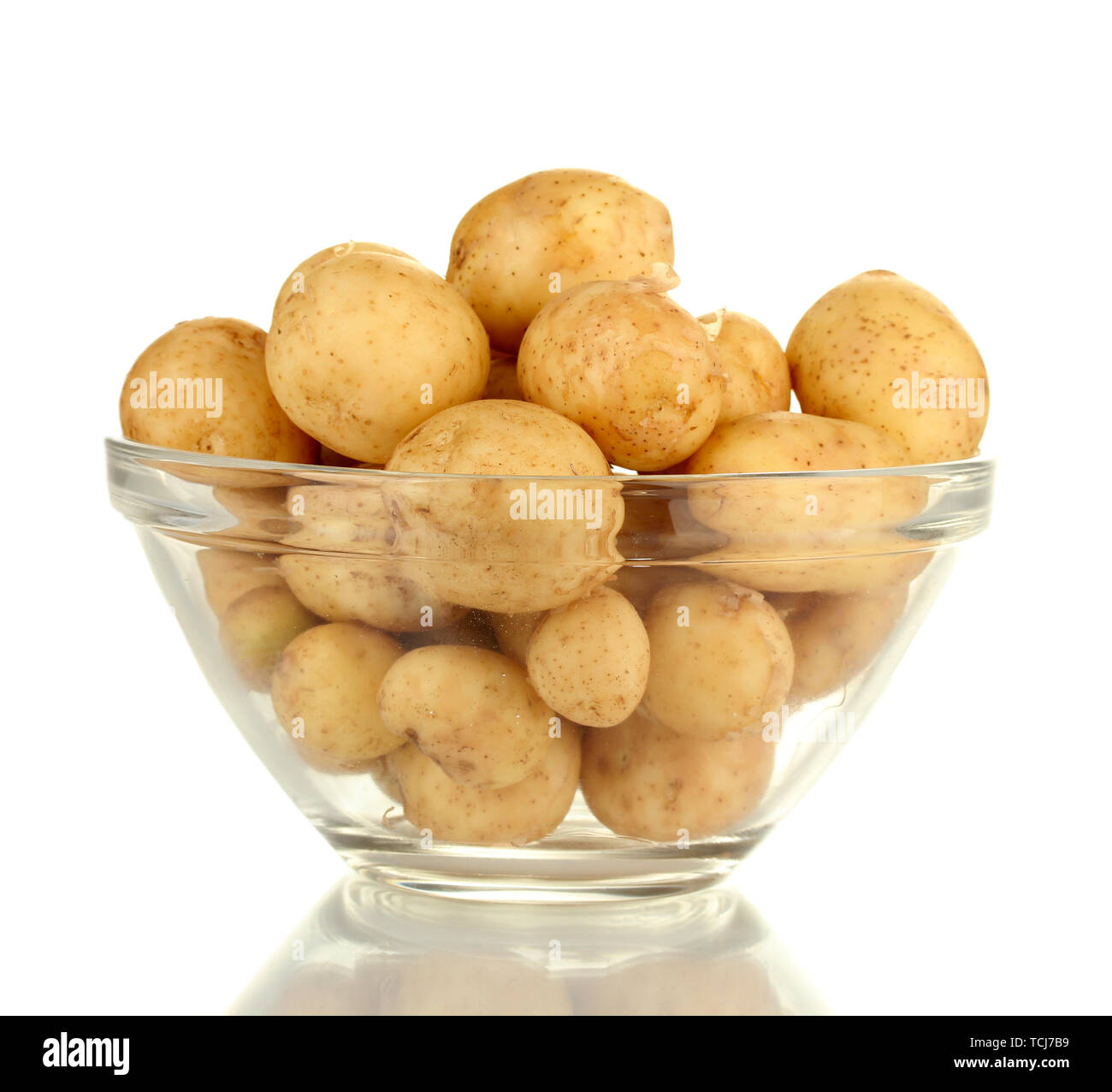 young potatoes in a glass bowl isolated on white Stock Photo - Alamy