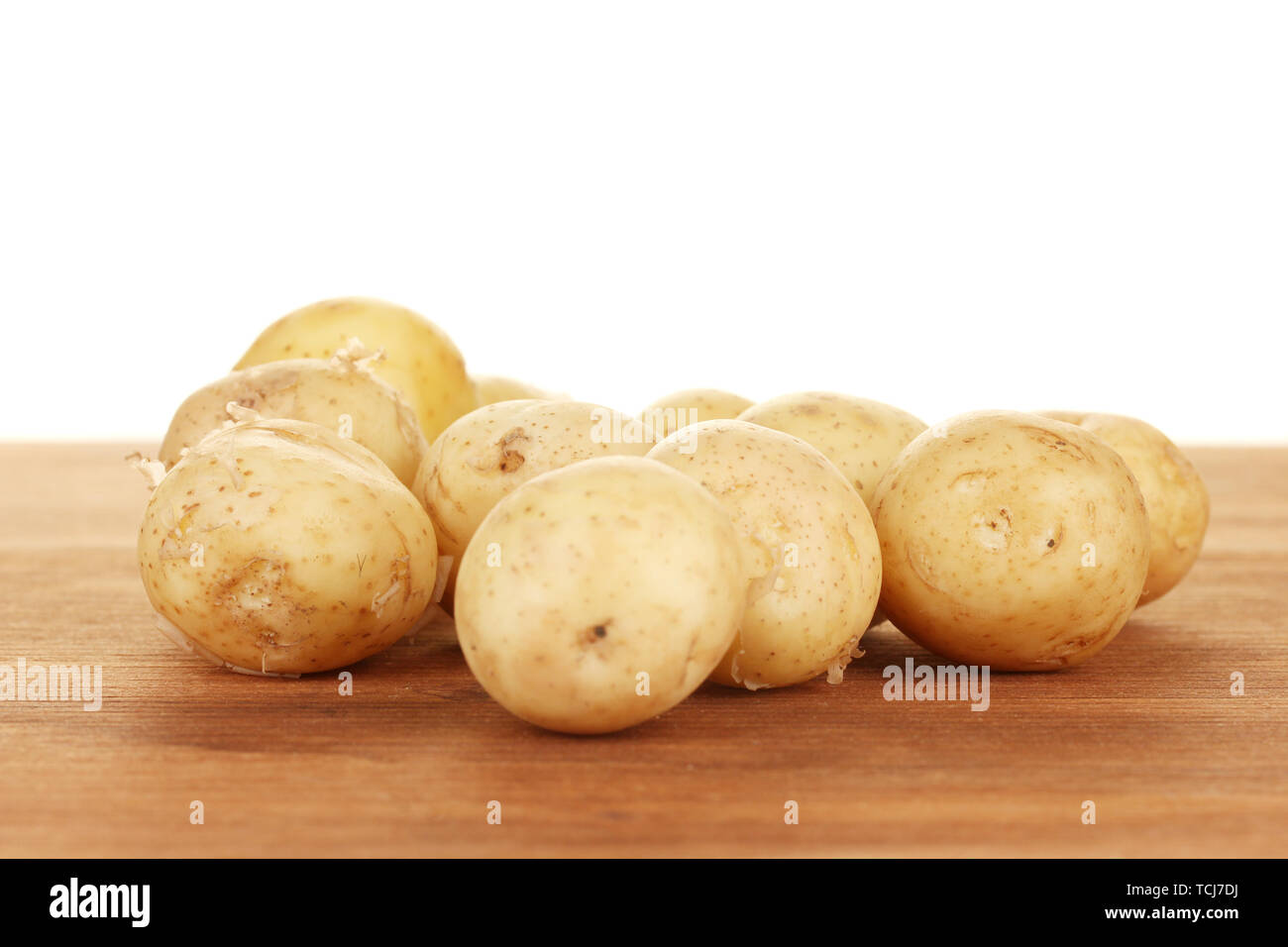 young potatoes on a table on white background Stock Photo - Alamy