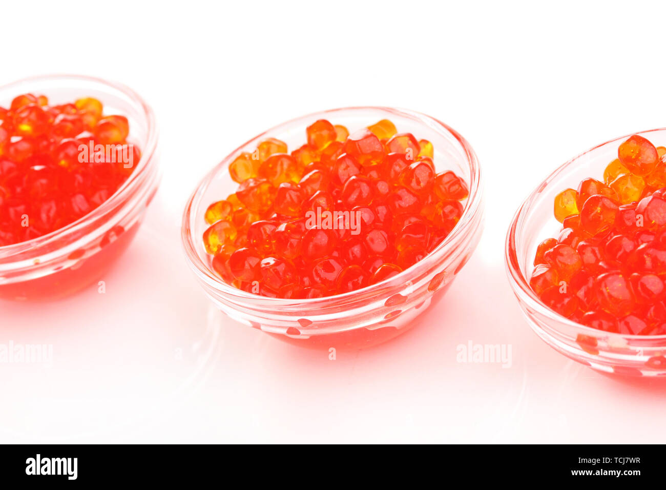 Red caviar in glass bowls isolated on white Stock Photo - Alamy
