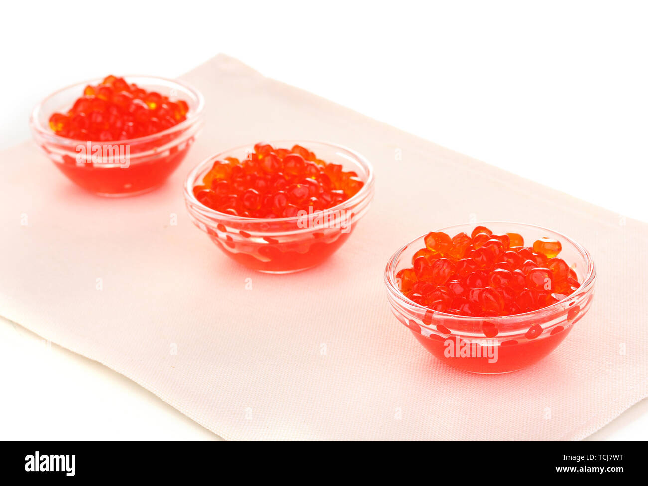 Red caviar in glass bowls isolated on white Stock Photo - Alamy
