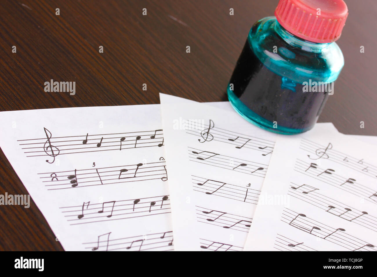 Musical notes on wooden table Stock Photo - Alamy