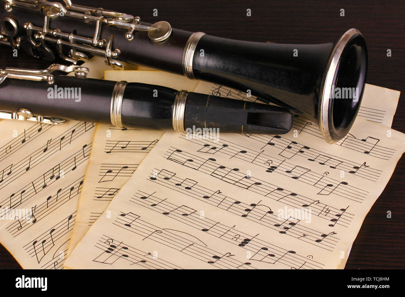 Musical notes and clarinet on wooden table Stock Photo - Alamy
