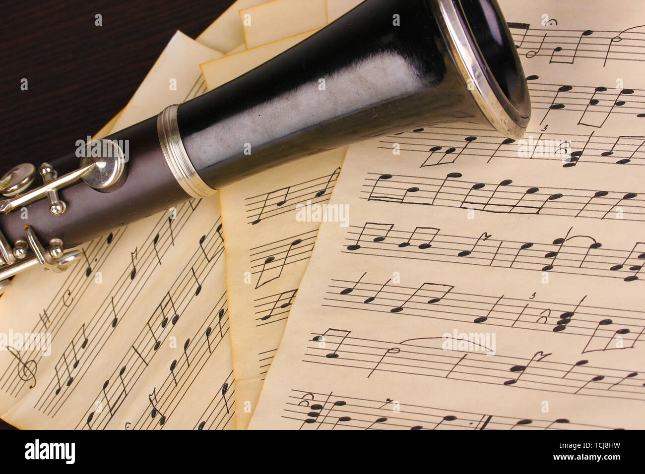 Musical notes and clarinet on wooden table Stock Photo - Alamy