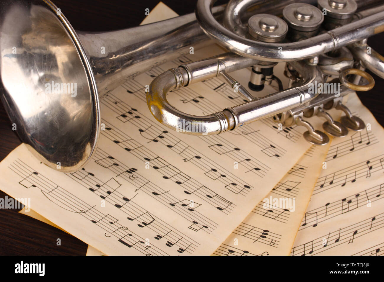 Musical notes and trumpet on wooden table Stock Photo - Alamy