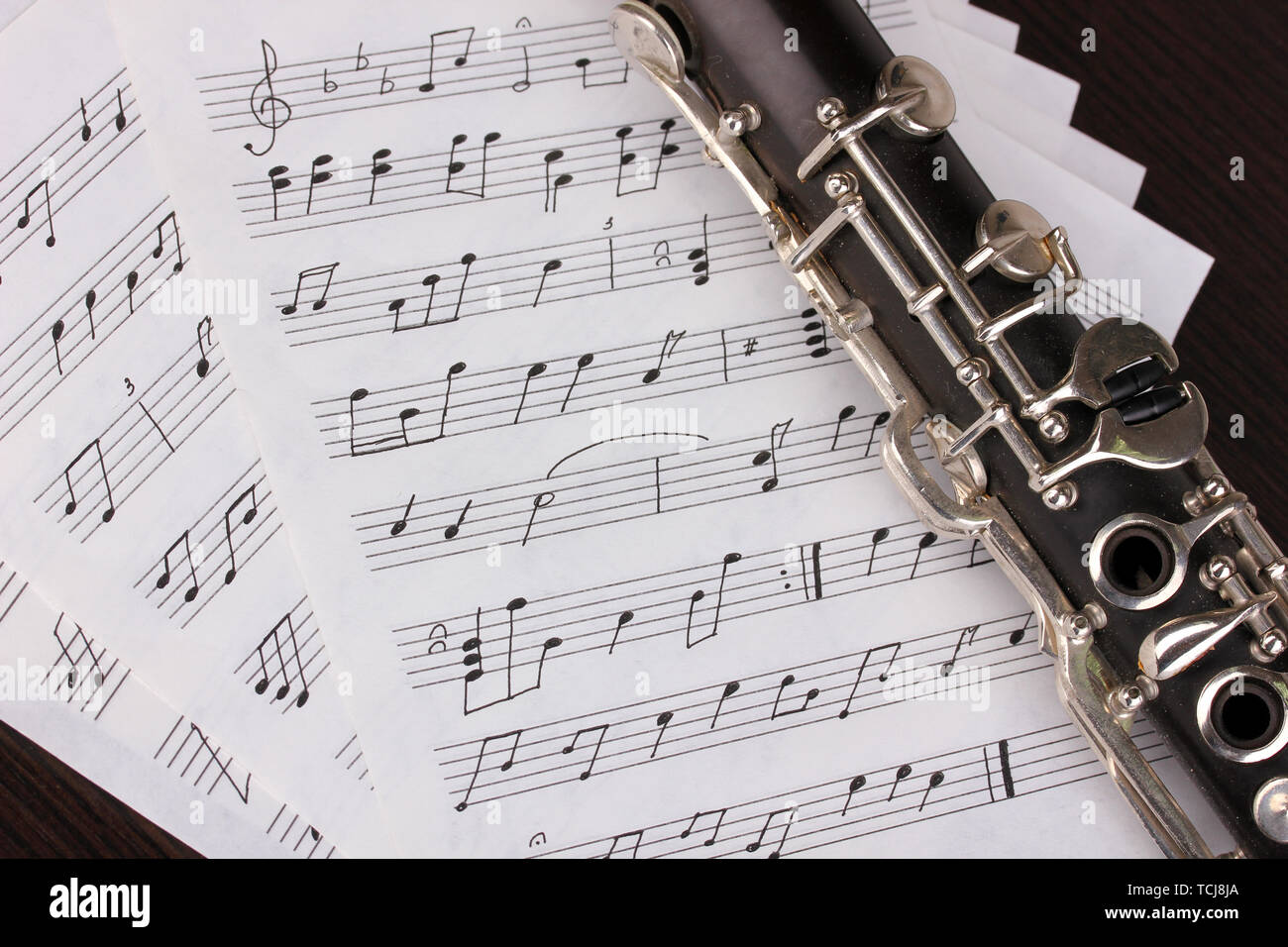 Musical notes and clarinet on wooden table Stock Photo - Alamy