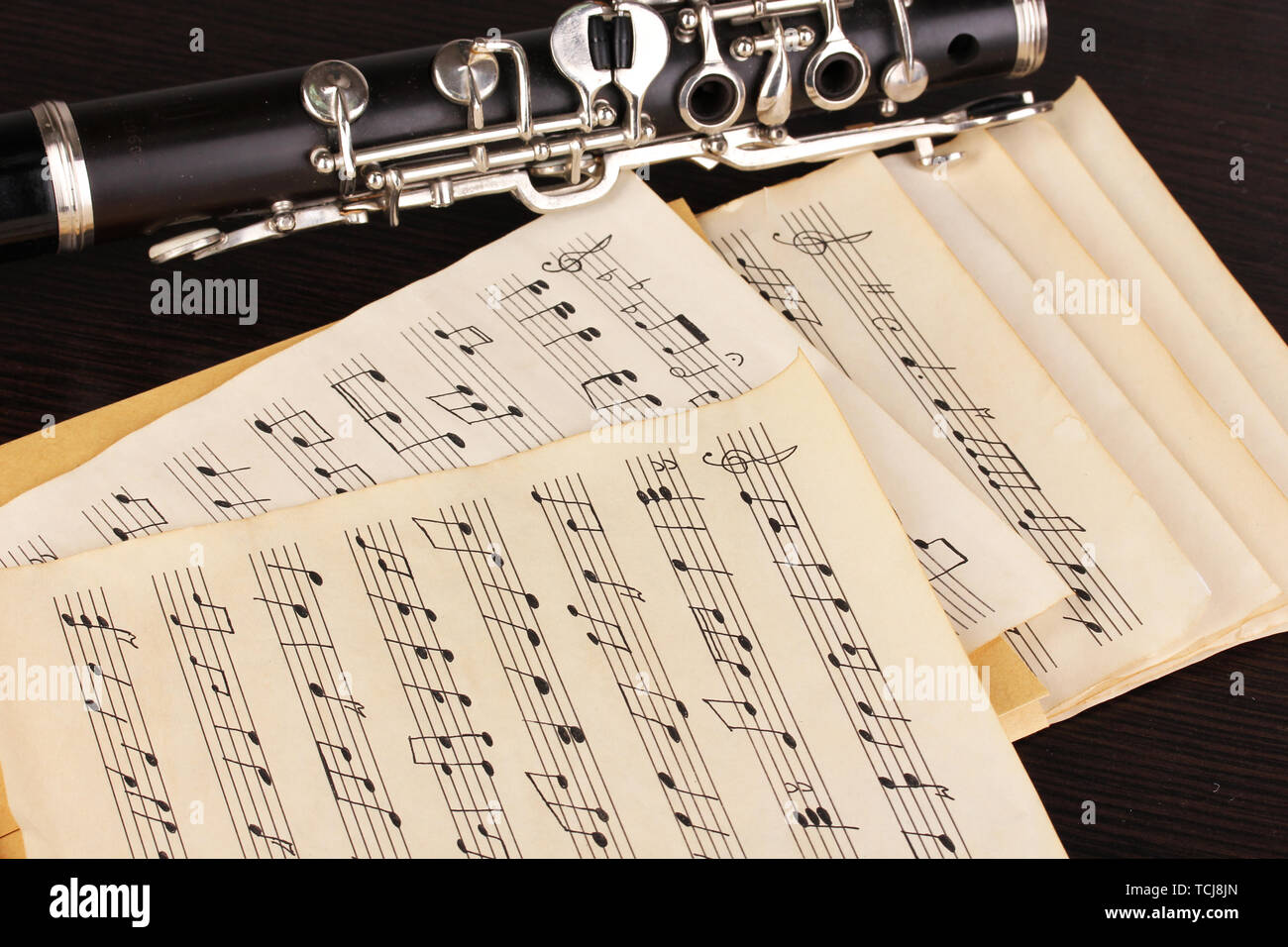 Musical notes and clarinet on wooden table Stock Photo - Alamy