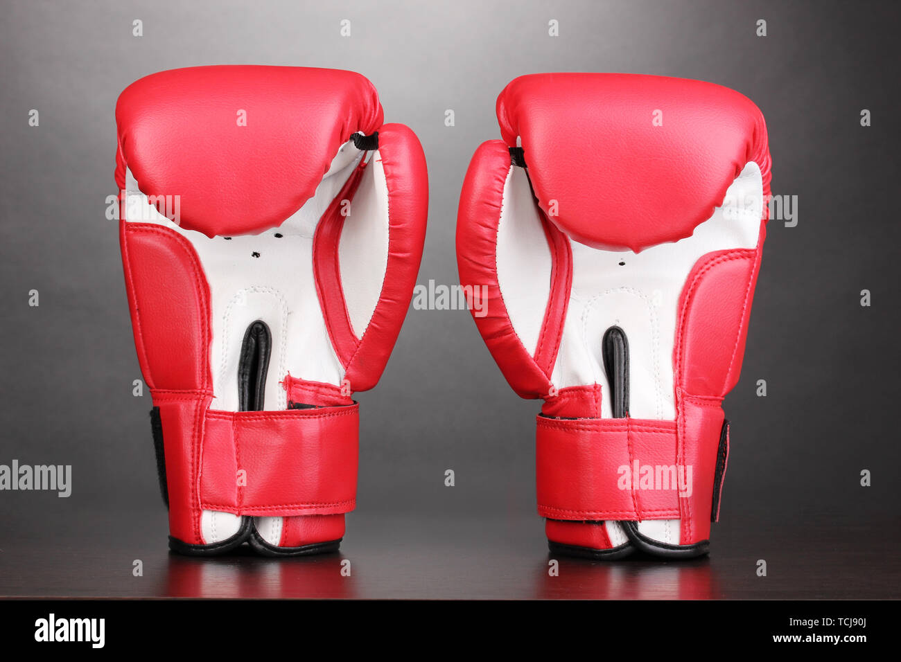 Red boxing gloves on grey background Stock Photo - Alamy