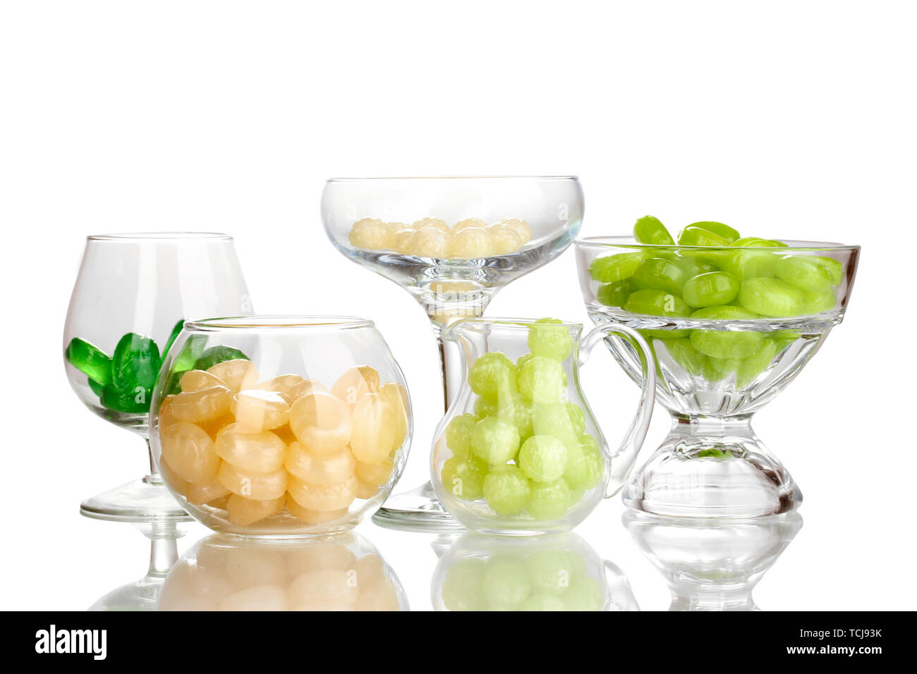 Color candies in glasses isolated on white Stock Photo - Alamy